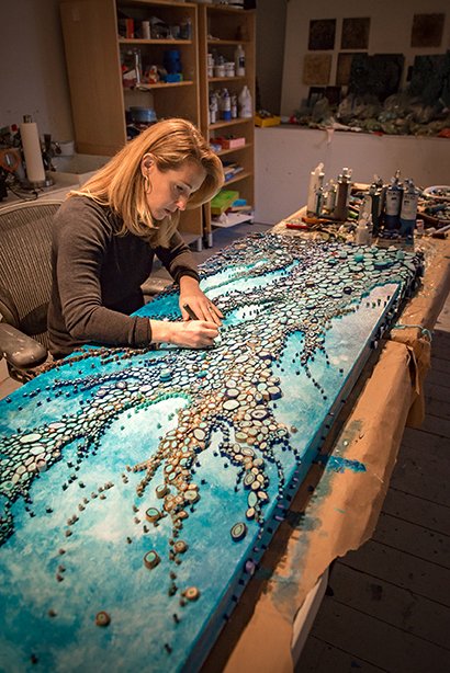 Paper artist Amy Genser works on one of her installations in her studio ...